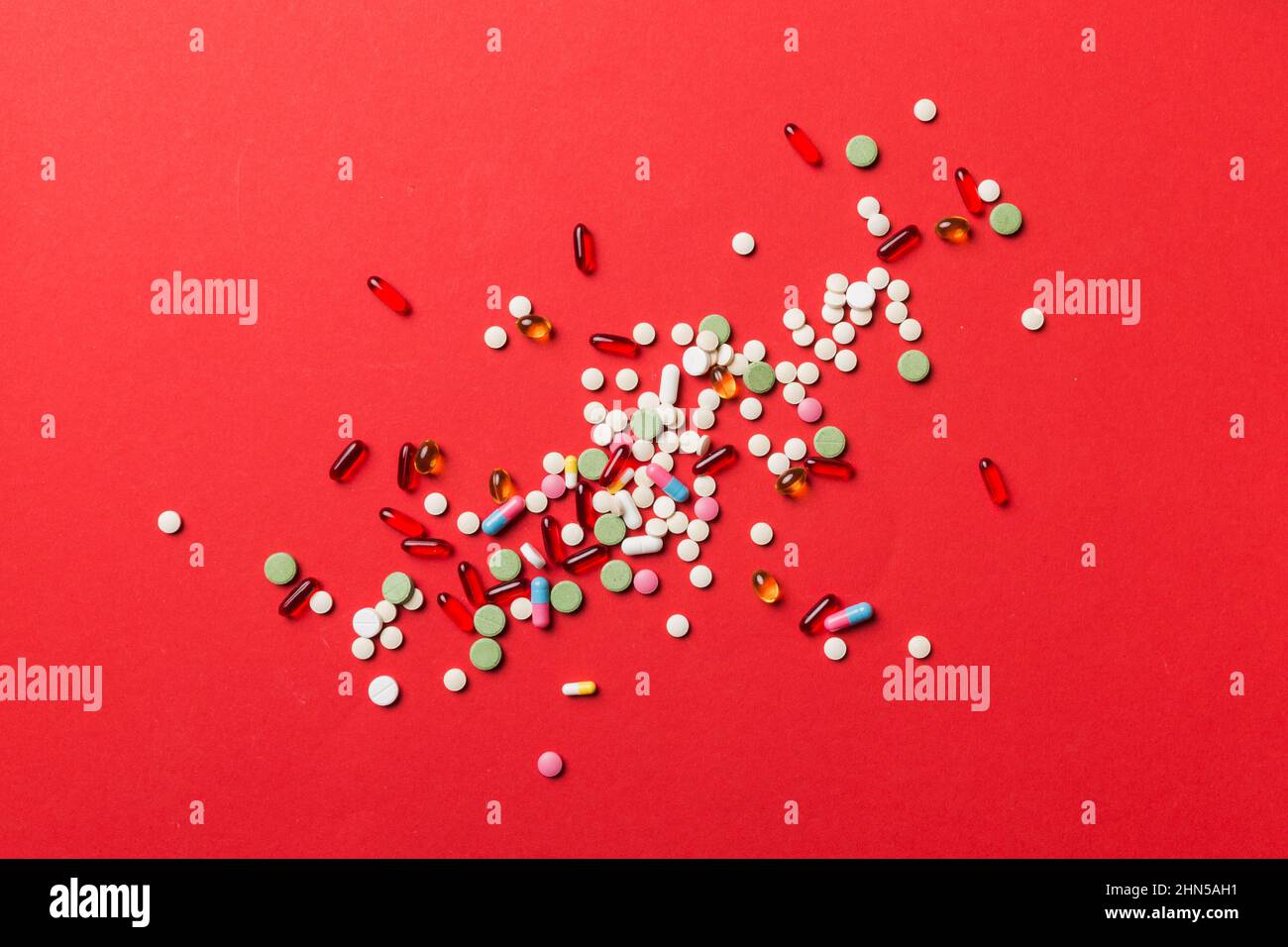 assorted pills and tablets top border over colored background. Many ...