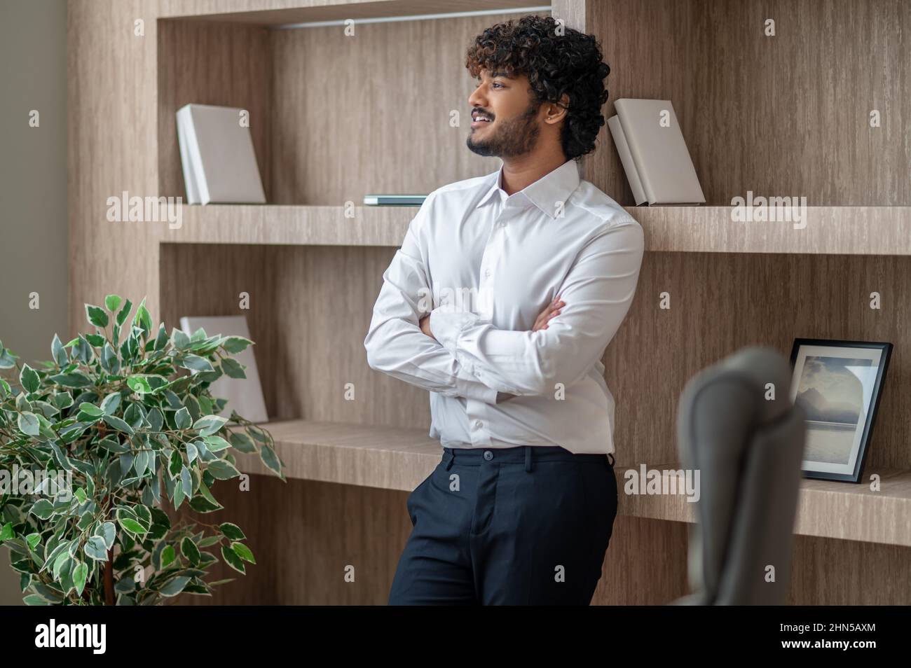 Young indian businessman sstanding with arms crossed Stock Photo - Alamy