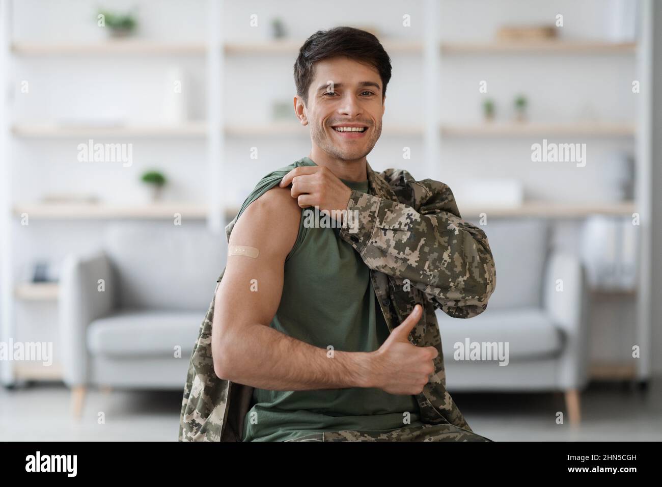 Happy military guy showing band on shoulder and thumb up Stock Photo ...