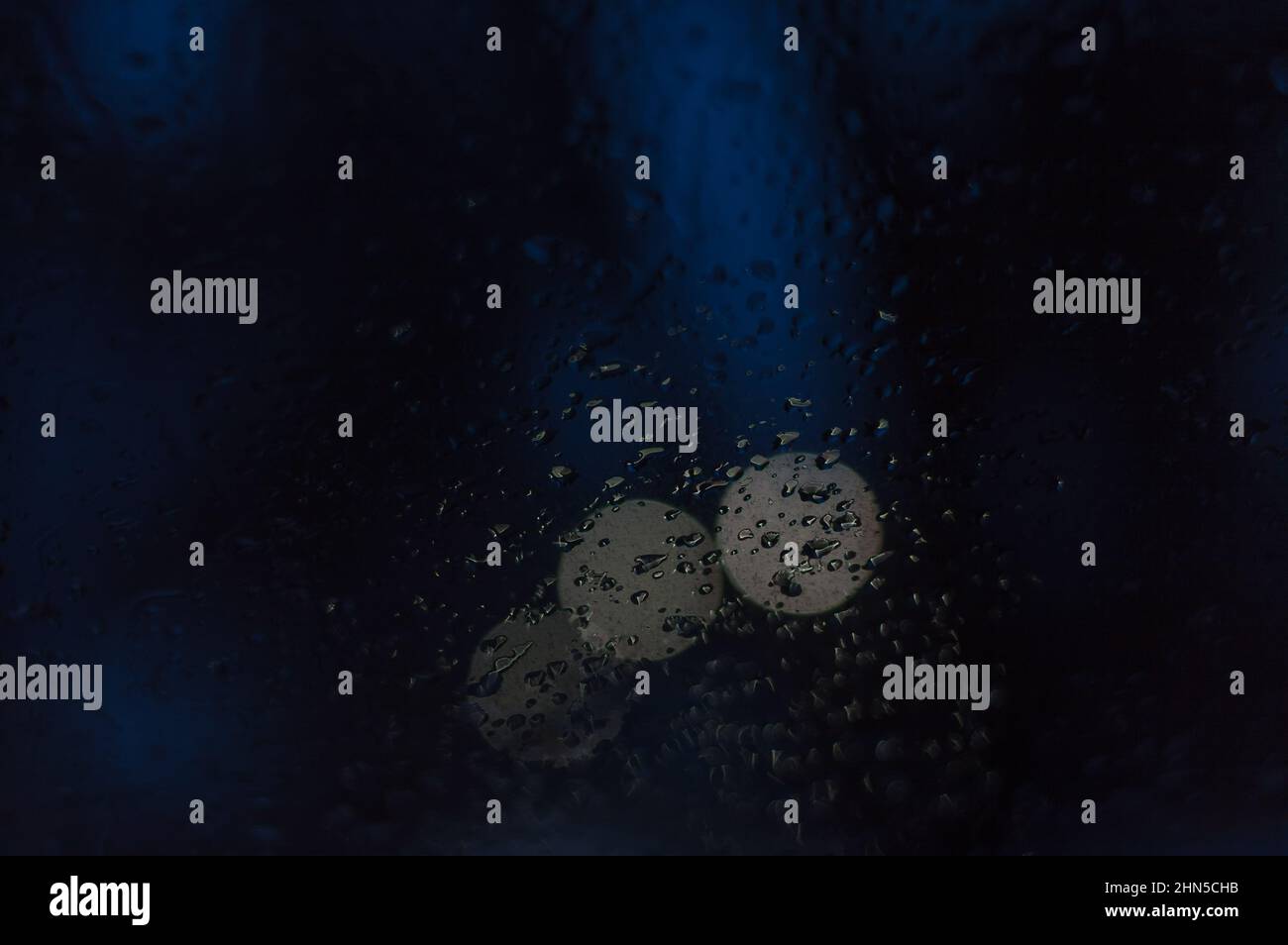 Abstract dark blue background with bright blue patches of color and ...