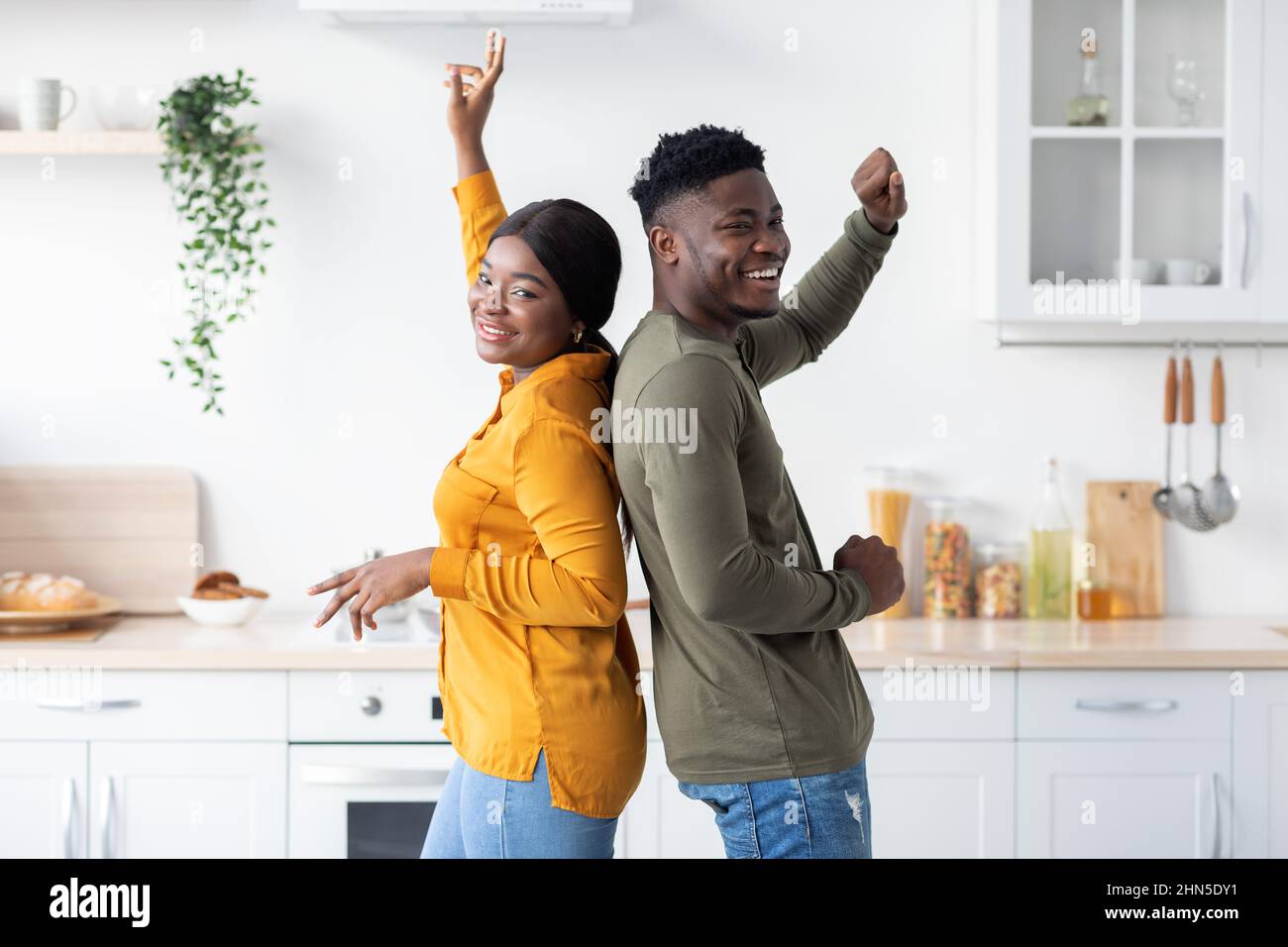 Home Fun. Cheerful African American Couple Dancing In Kitchen Interior ...