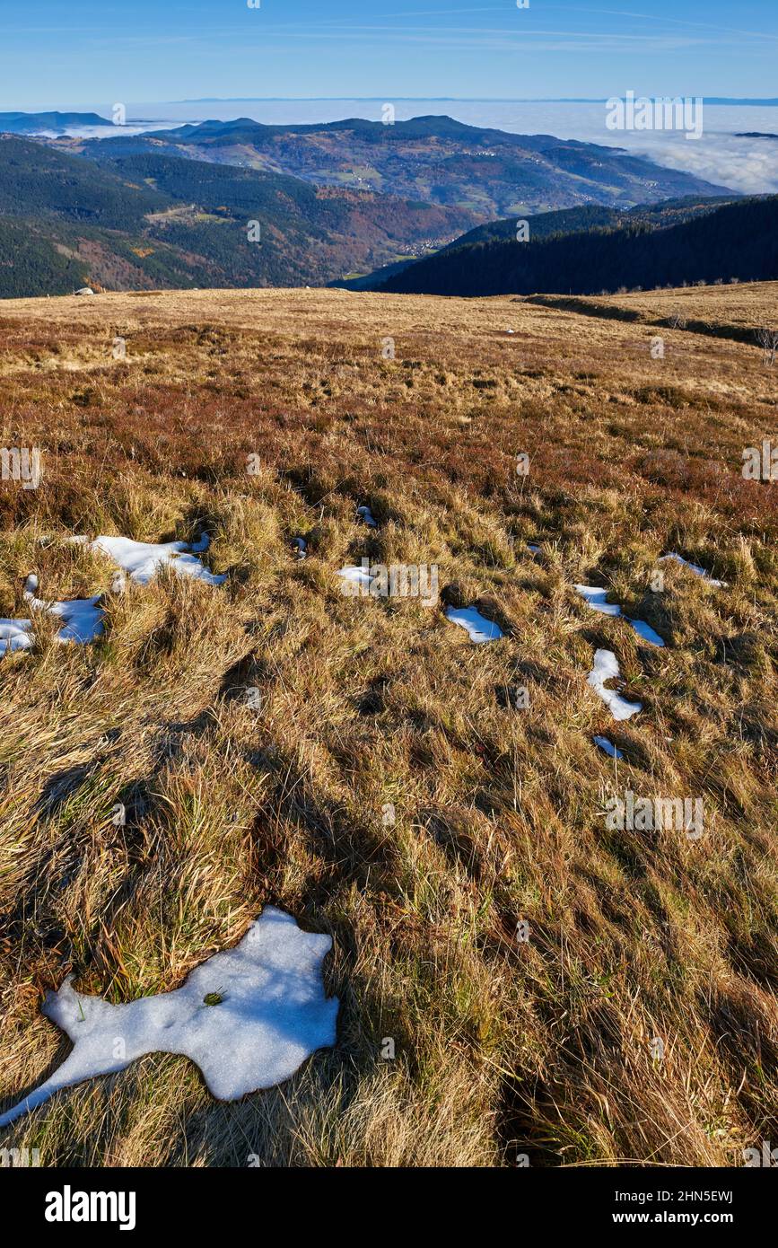 Layered mountain landscape with patches of snow in the grass Stock ...