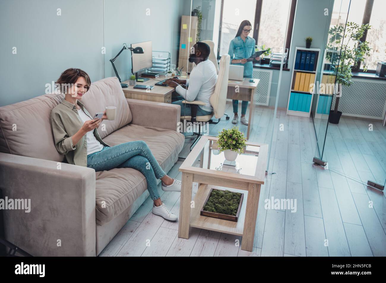 Photo of happy positive advisors sitting table having pause typing ...