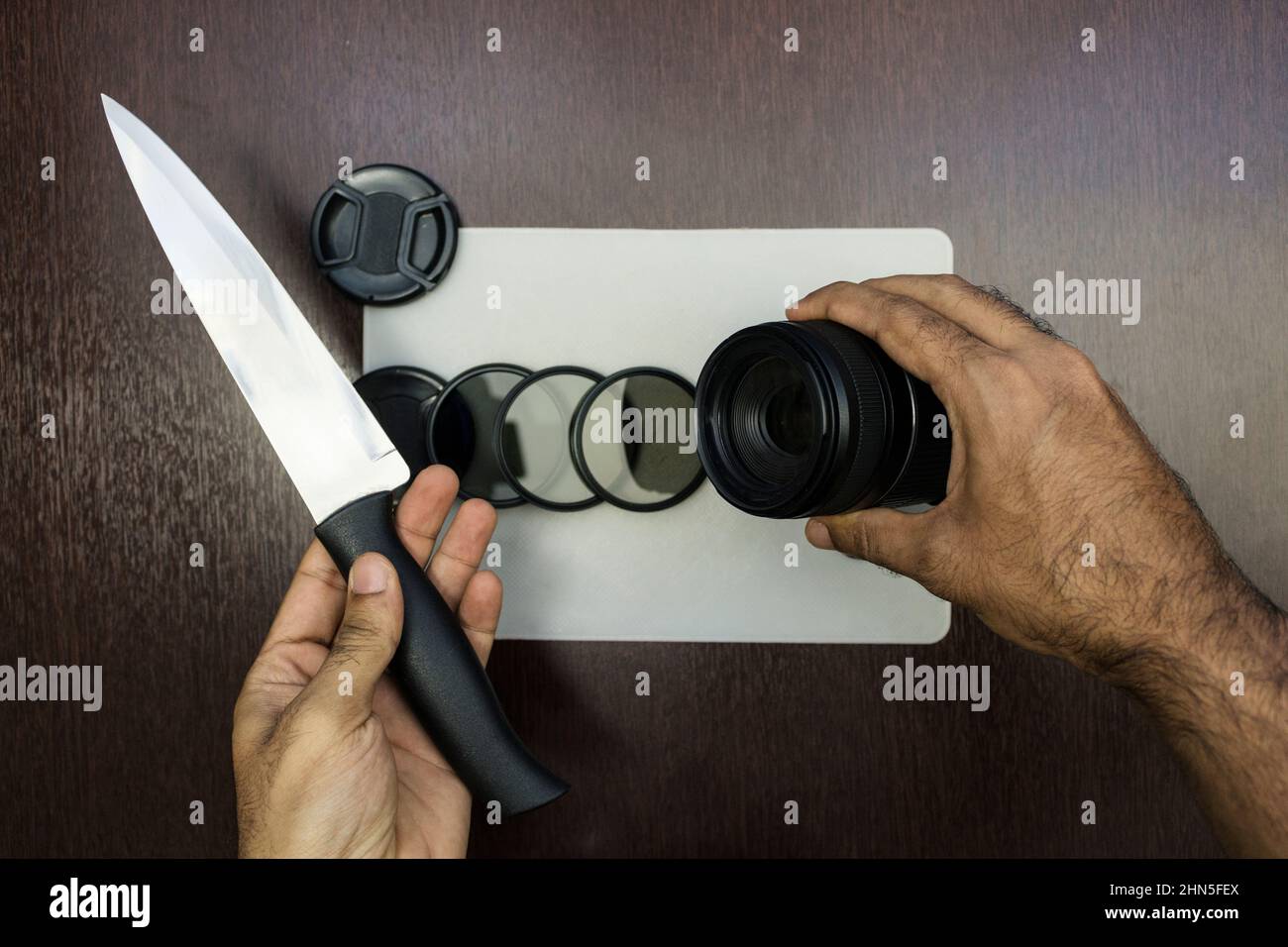 Cutting photo lenses on wooden table. Creative photographer concept ...