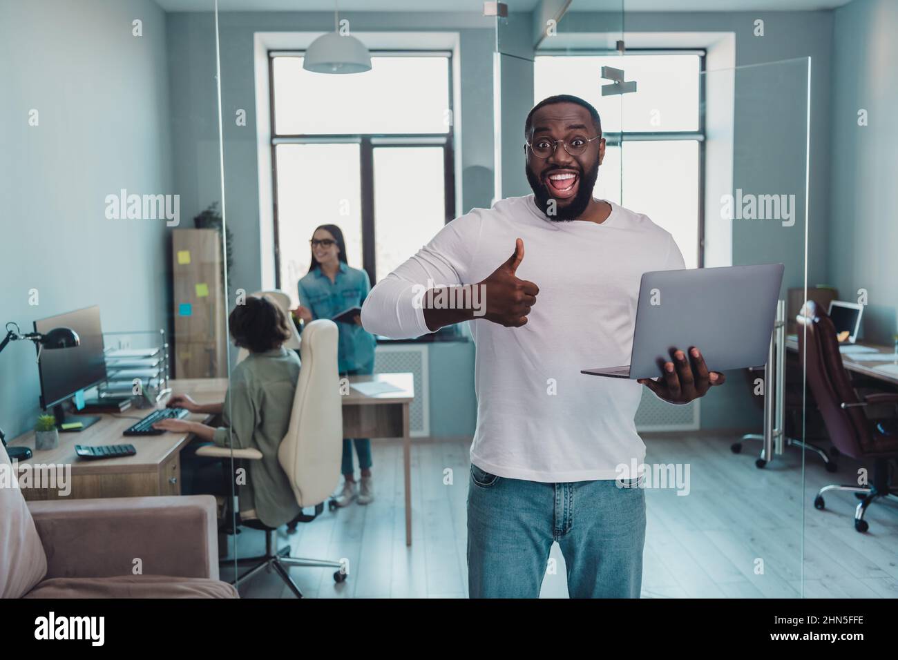 Portrait of handsome beautiful cheerful group guy using laptop showing ...