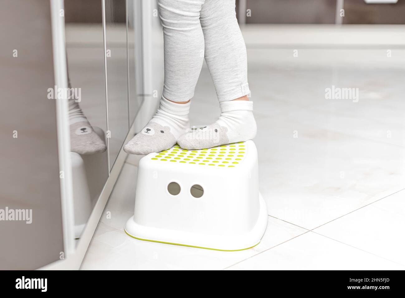 Small feet stand on a stand for children Stock Photo - Alamy