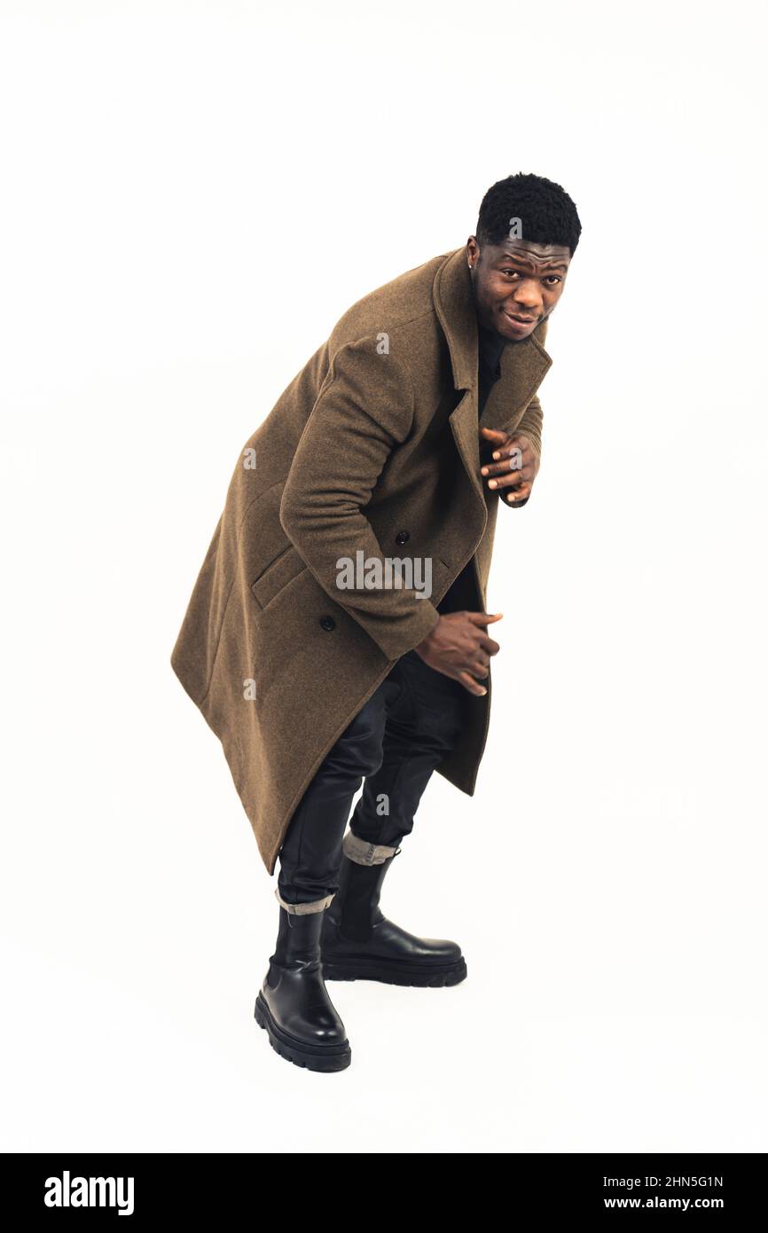 person of color showing coat to model standing white background - full ...