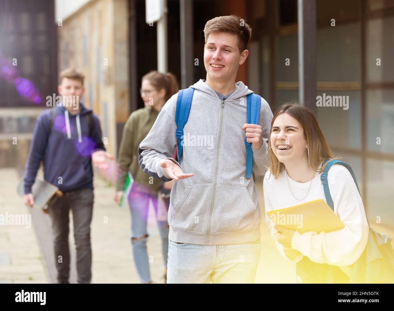 Carefree teen students boy and girl friendly talking Stock Photo - Alamy