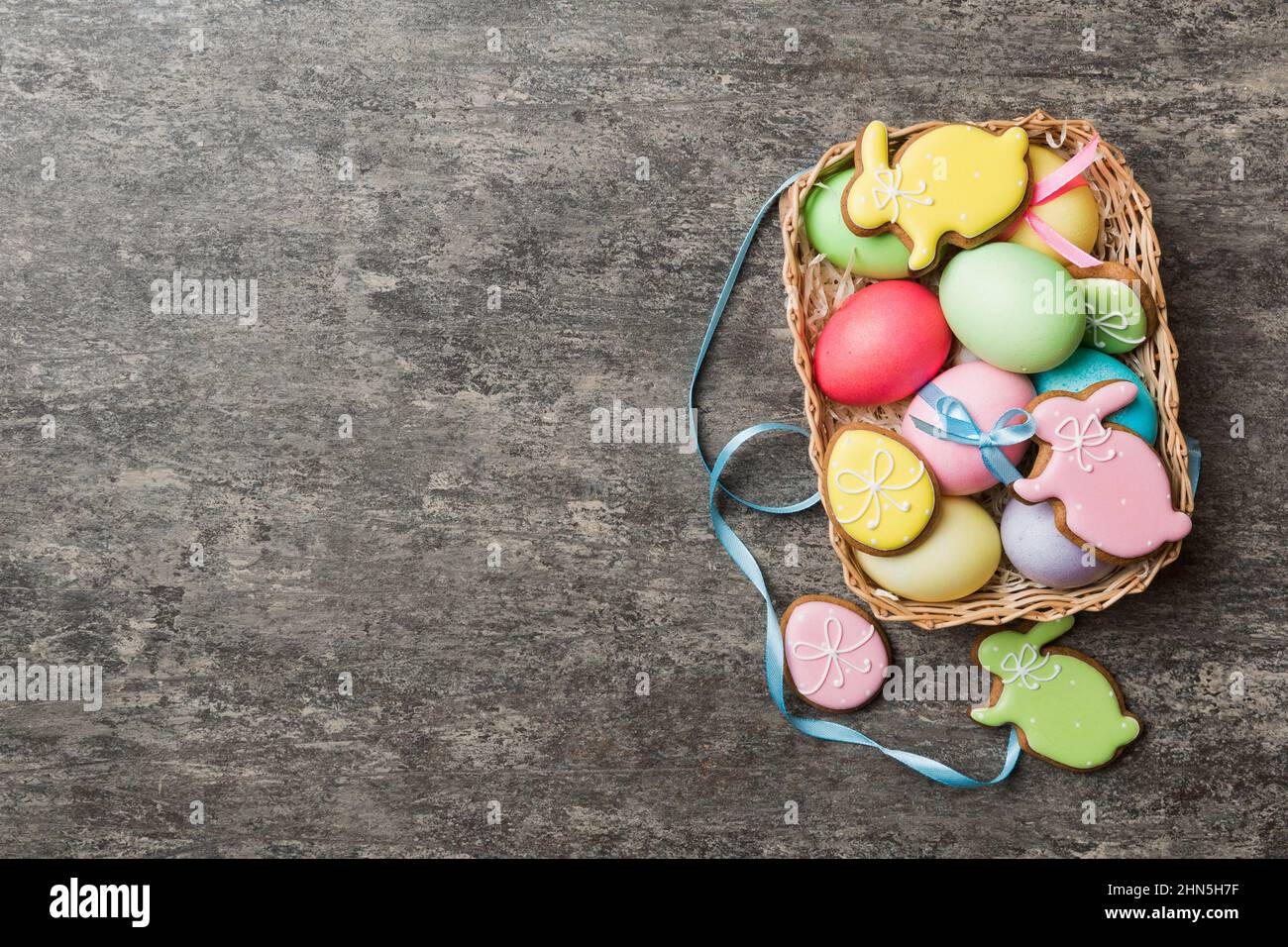 Colorful easter cookies in basket with Multi colors Easter eggs on ...