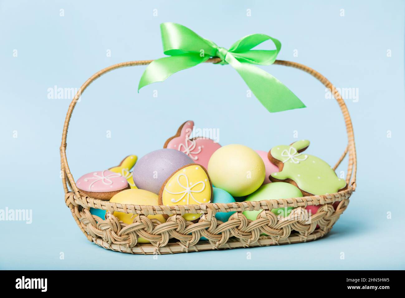 Colorful easter cookies in basket with Multi colors Easter eggs on ...