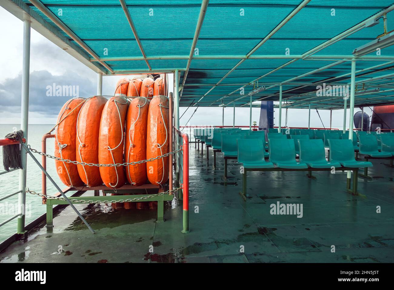Orange inflatable lifeboats on ferry deck for emergencies and maritime ...