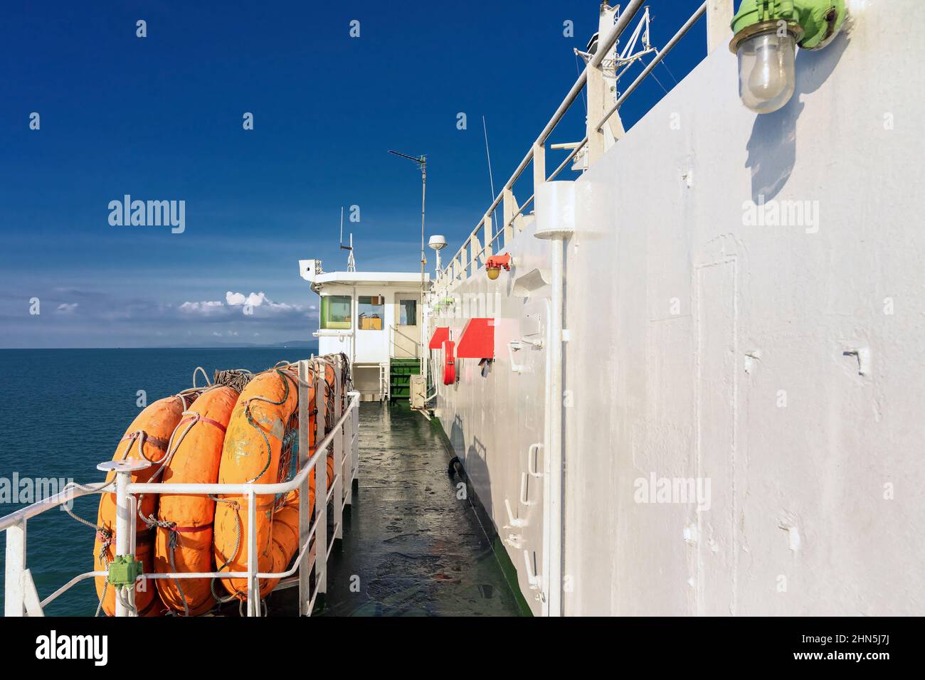 Orange inflatable lifeboats on ferry deck for emergencies and maritime ...