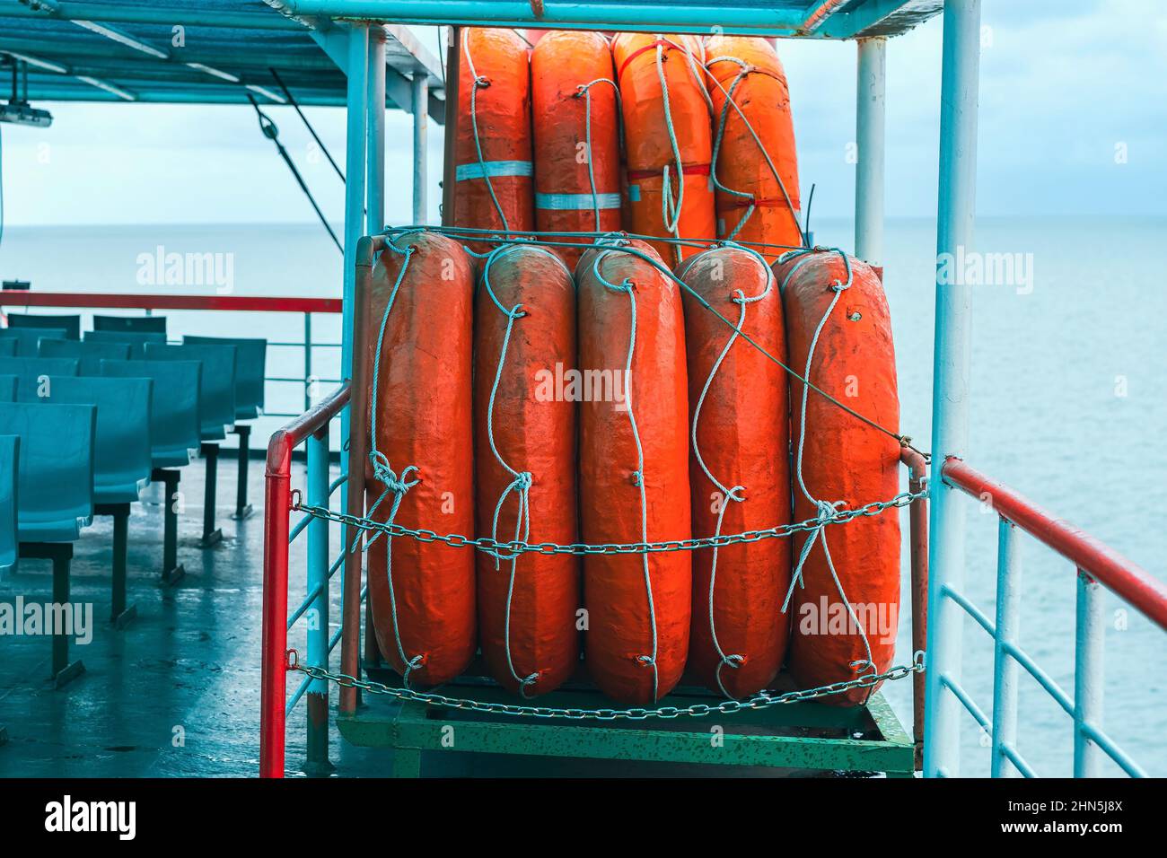 Orange inflatable lifeboats on ferry deck for emergencies and maritime ...