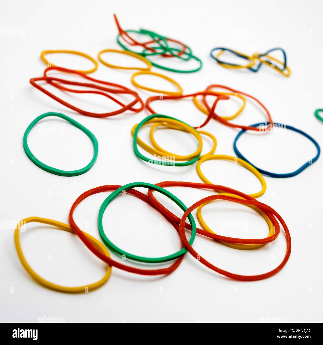 Colorful rubber bands scattered on a white surface Stock Photo - Alamy