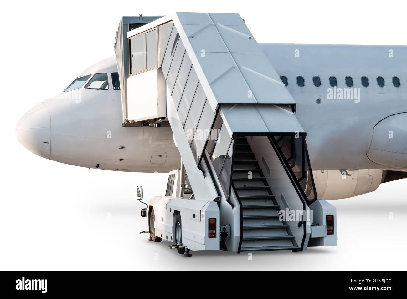 Passenger airliner with a boarding ramp isolated on white background ...