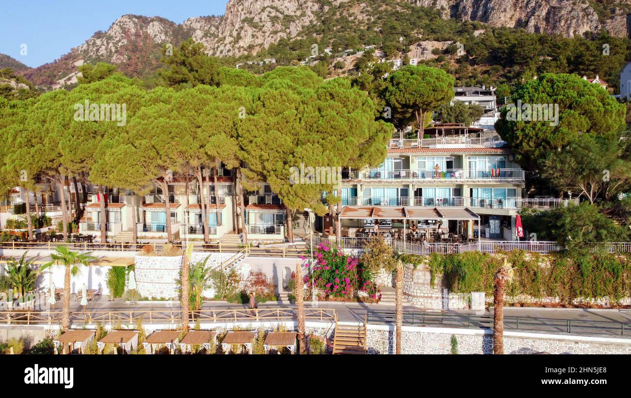 Aerial view of tourist hotel with with planted pines in resort village ...