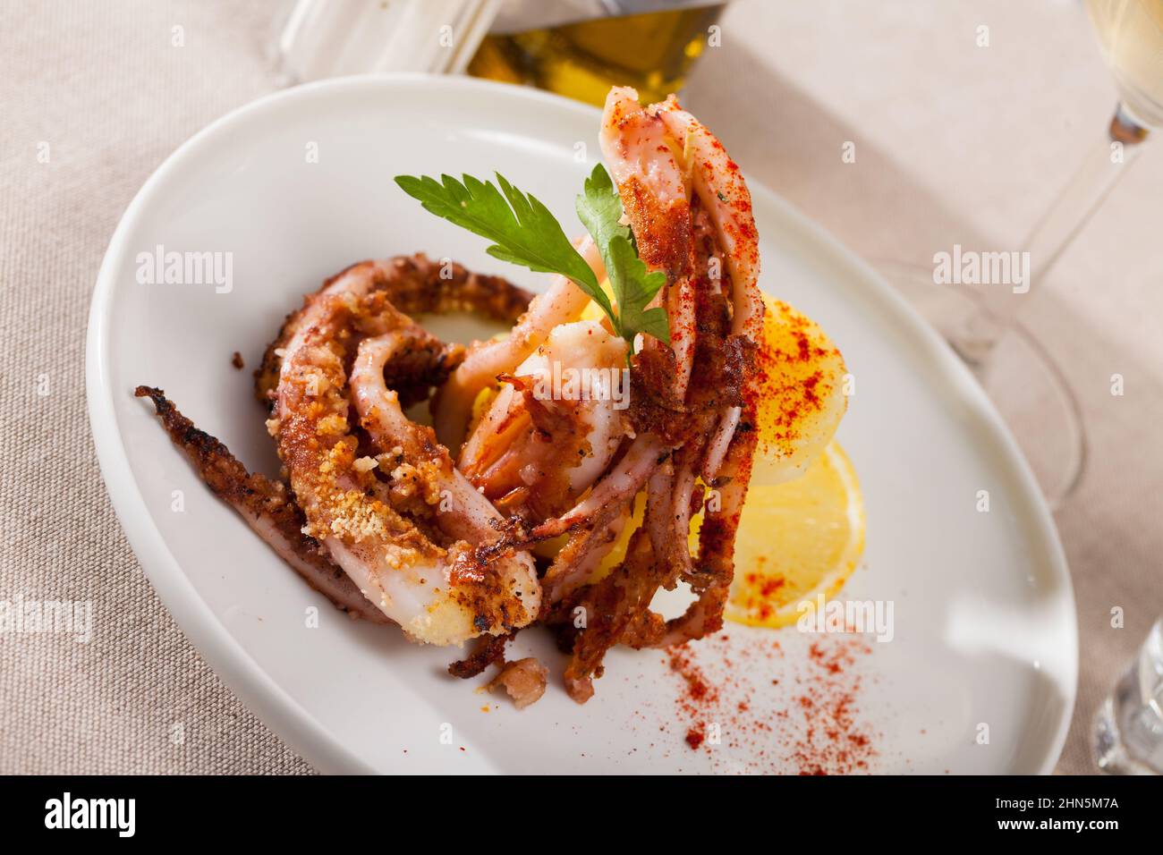 Roasted squid legs with lemon Stock Photo - Alamy