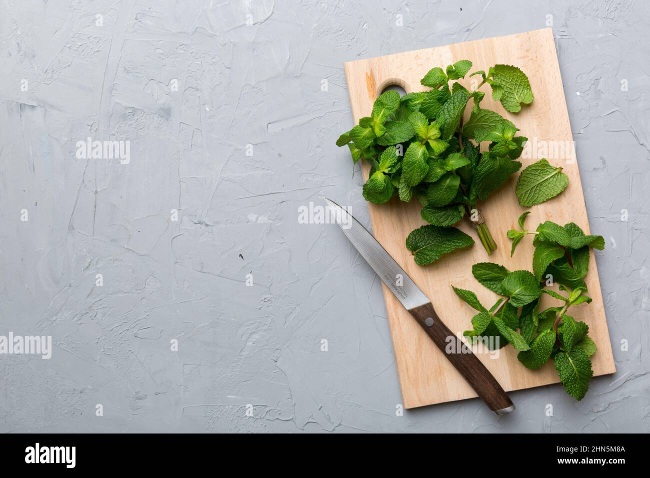 Fresh mint on Cutting board table, top view. Flat lay Space for text ...