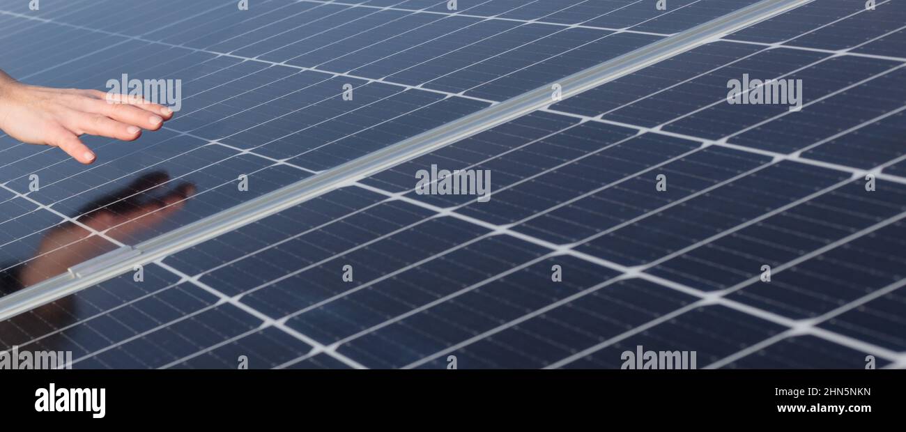 A hand touching the solar panels, close-up. Solar energy concept Stock ...