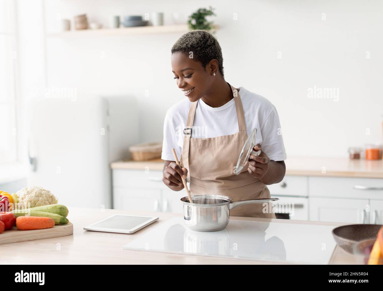 African lady lady cooking hi-res stock photography and images - Alamy