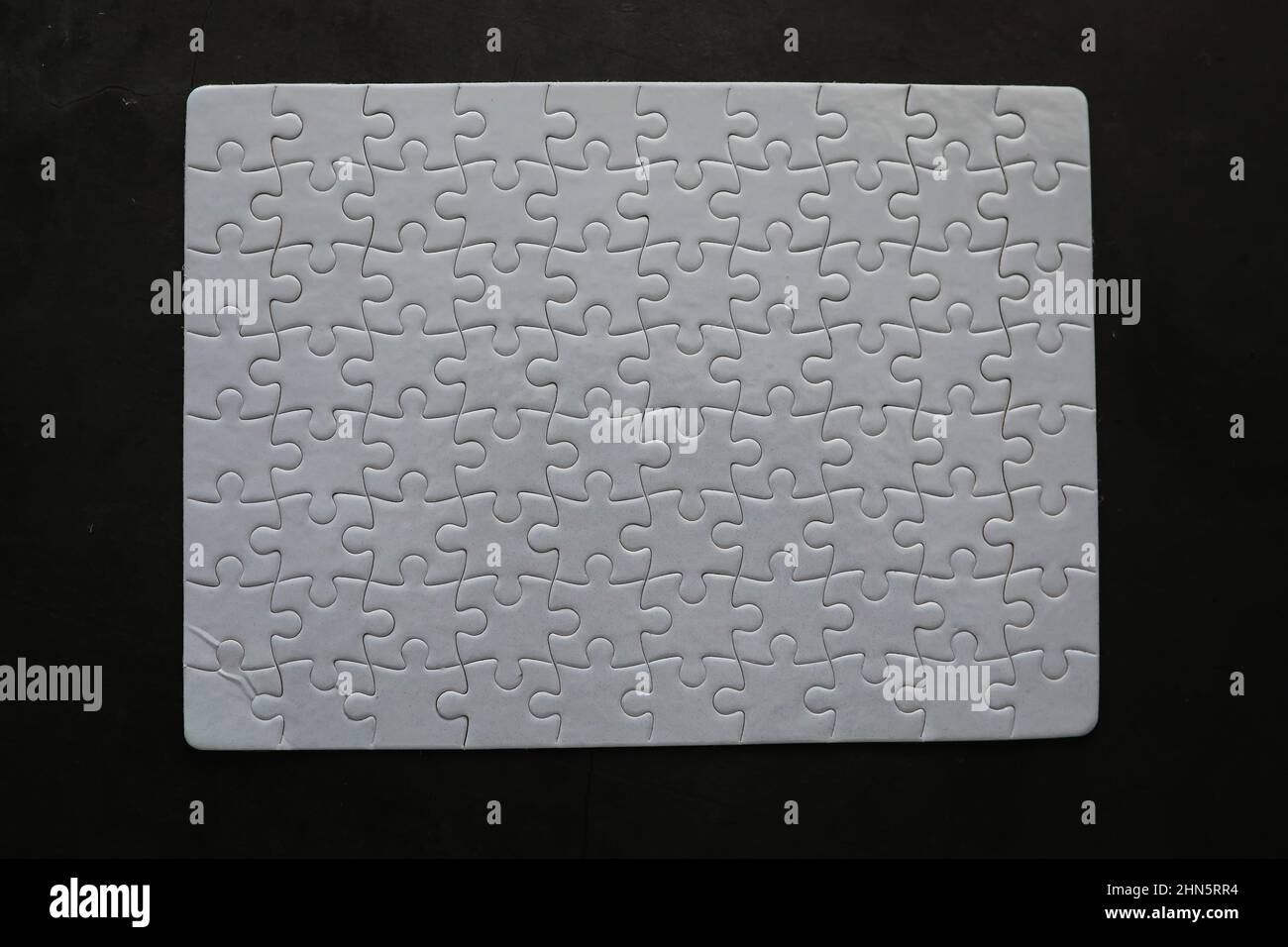 Intellectual puzzles. The puzzle empty. The hand puts together puzzle ...