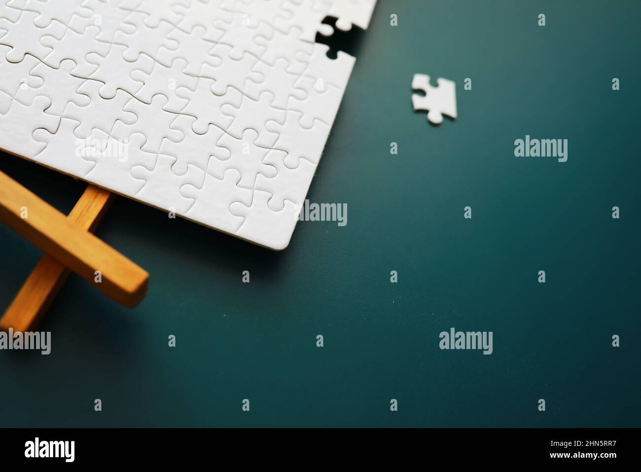 Intellectual puzzles. The puzzle empty. The hand puts together puzzle ...