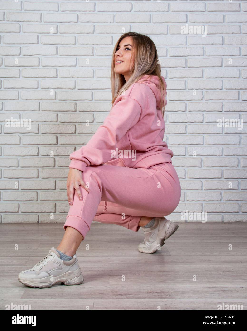 Beautiful woman in pink sport clothes on bright background Stock Photo ...