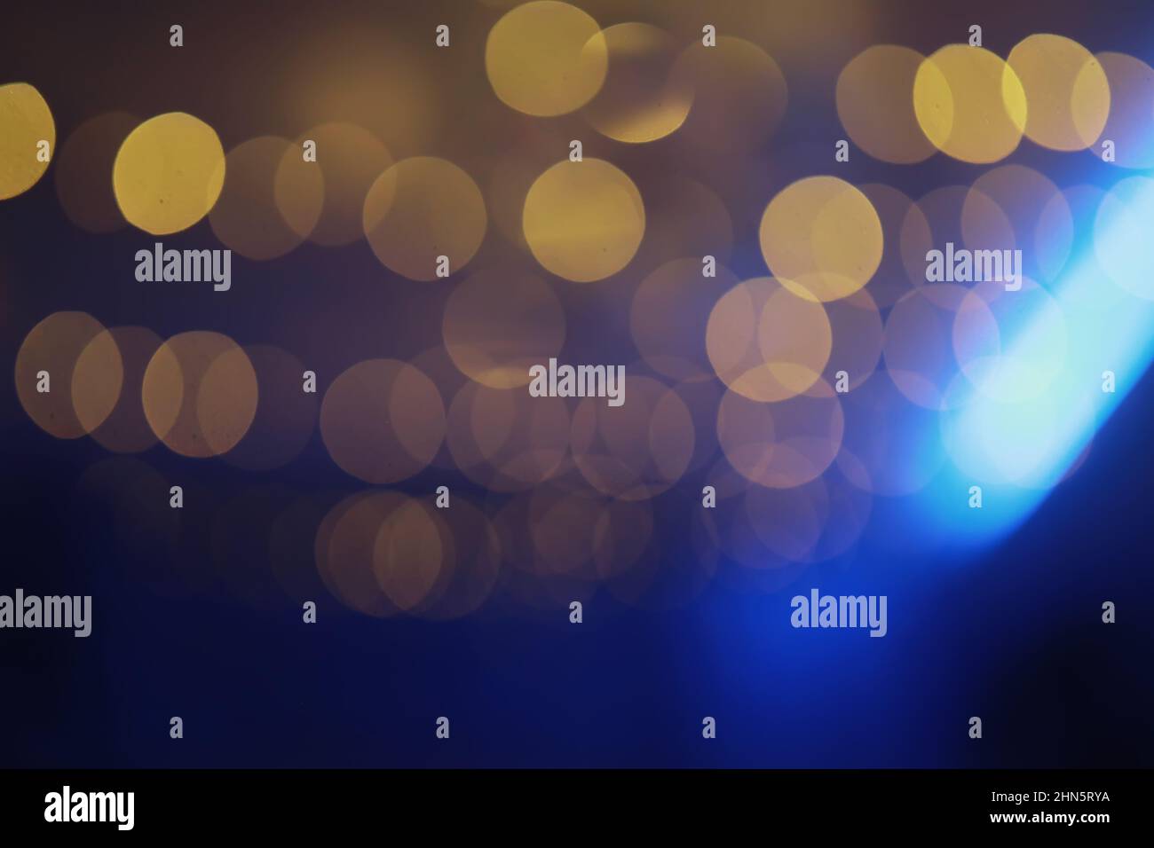 Abstract bokeh background. Golden bokeh circles on a dark blue ...
