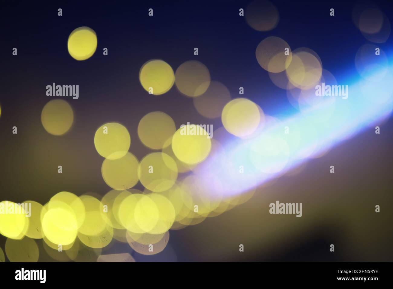 Abstract bokeh background. Golden bokeh circles on a dark blue ...