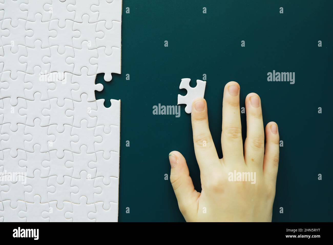 Intellectual puzzles. The puzzle empty. The hand puts together puzzle ...