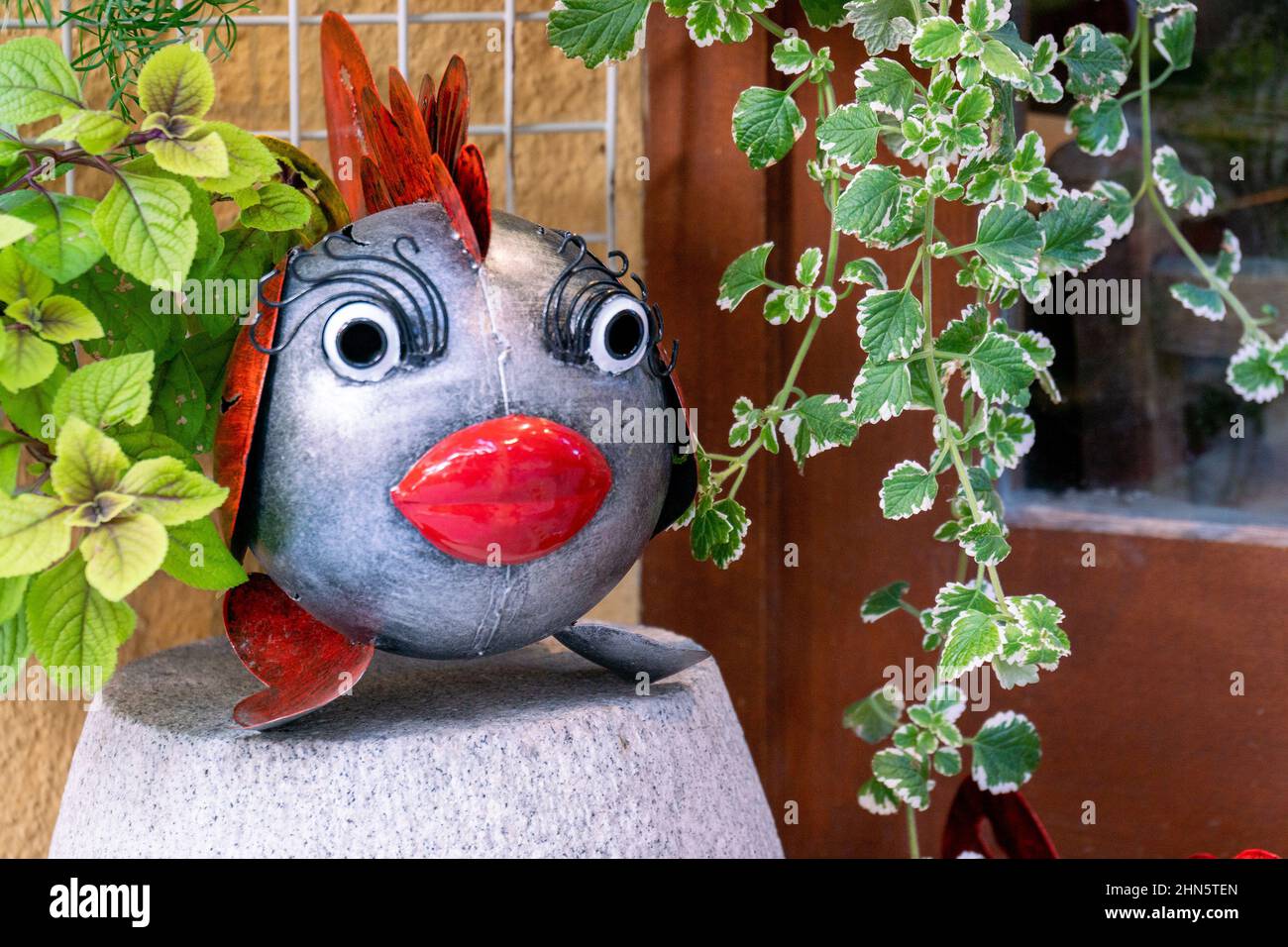 Souvenir. Figure fish with red lips and fins Stock Photo - Alamy