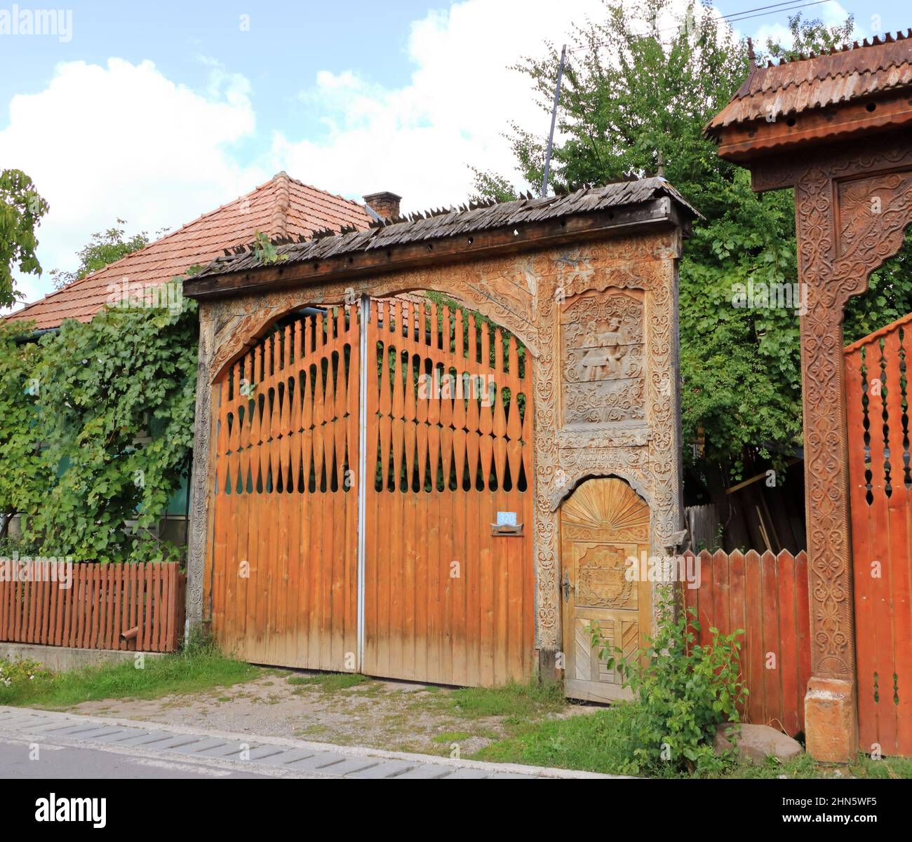 Traditional wood sculpture, decorated gate in Maramures in Romania ...