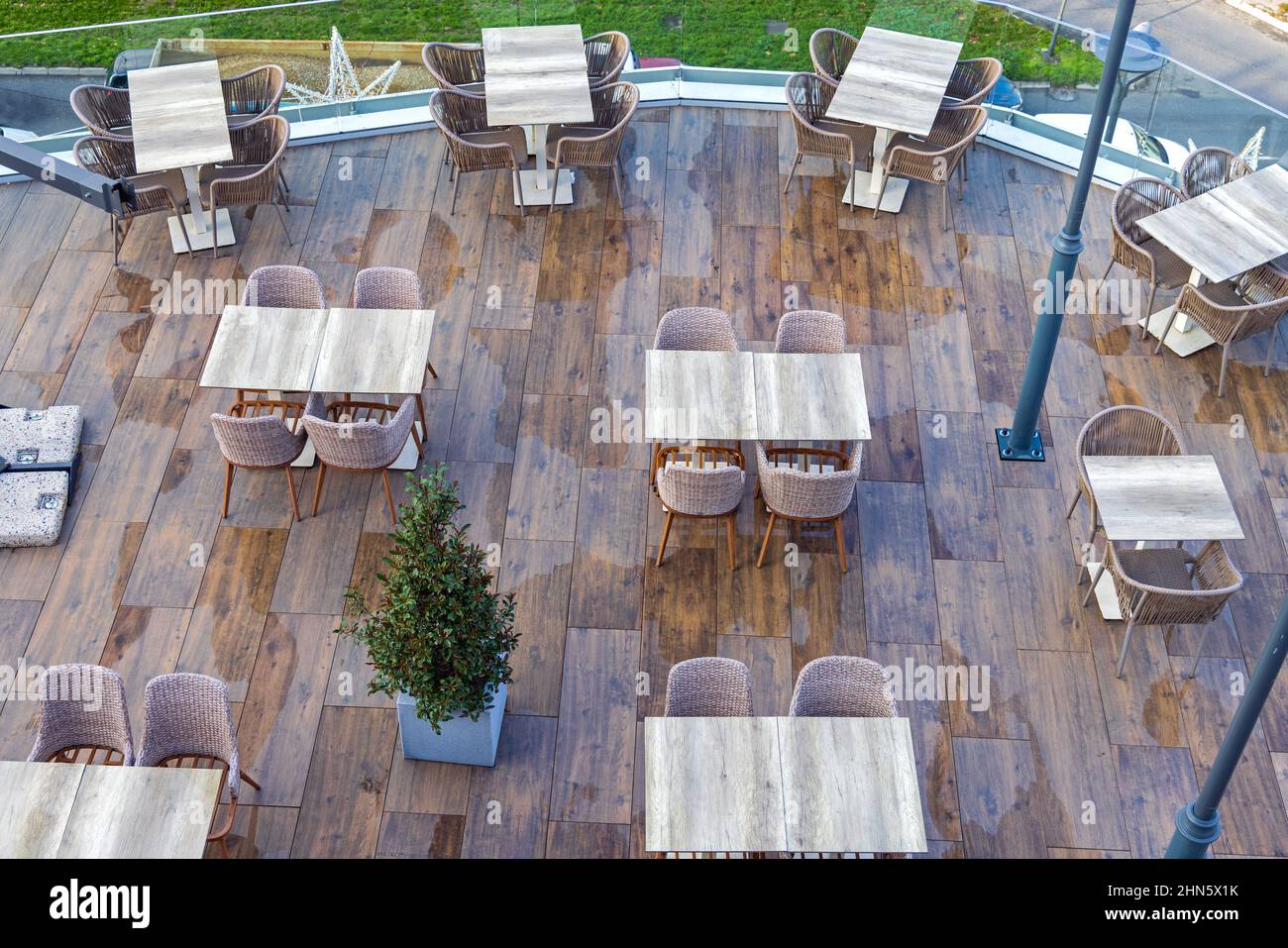 Tables With Chairs at Wet Tiles Terrace Patio Top View Stock Photo - Alamy