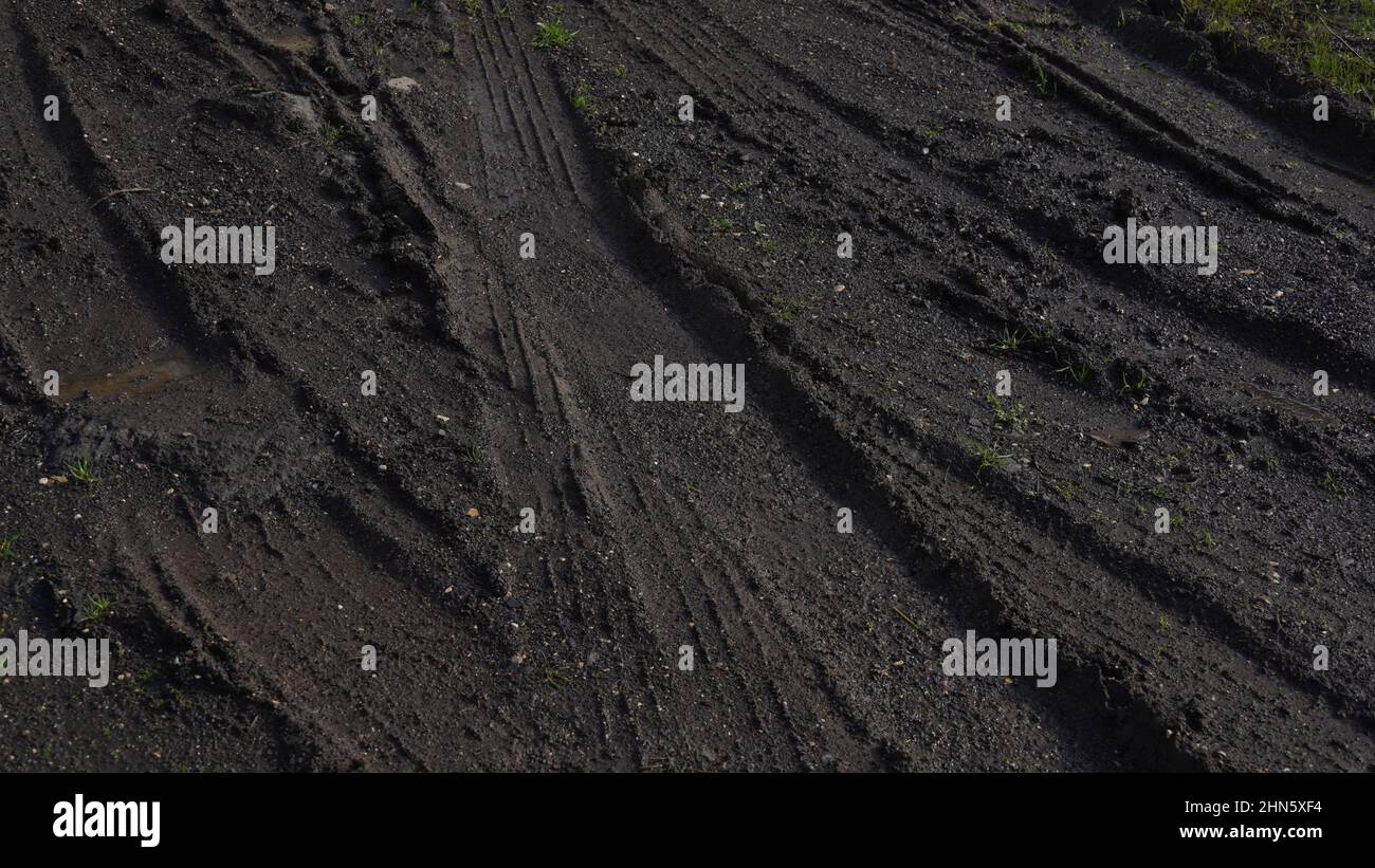 Muddy field with tire tracks and puddles. Dirty road with mud truck ...