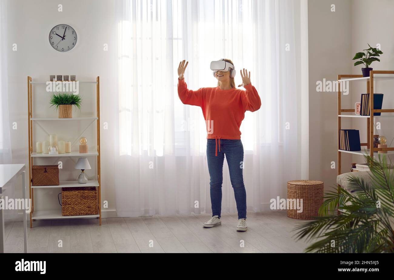 Woman in VR glasses touches augmented reality objects interacting with ...