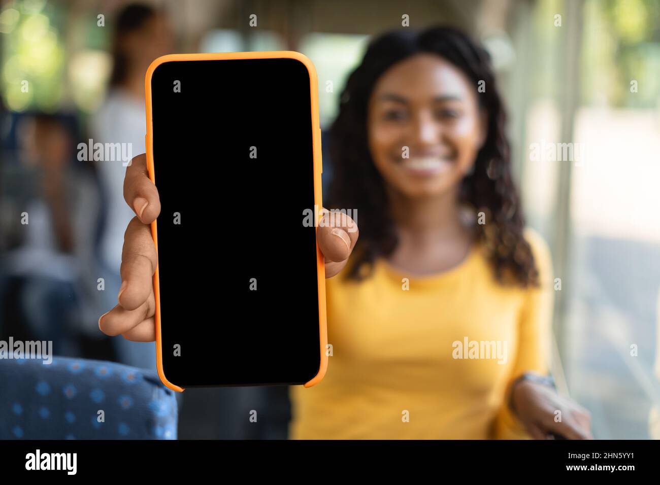 African american lady tourist showing blank smartphone screen, closeup ...