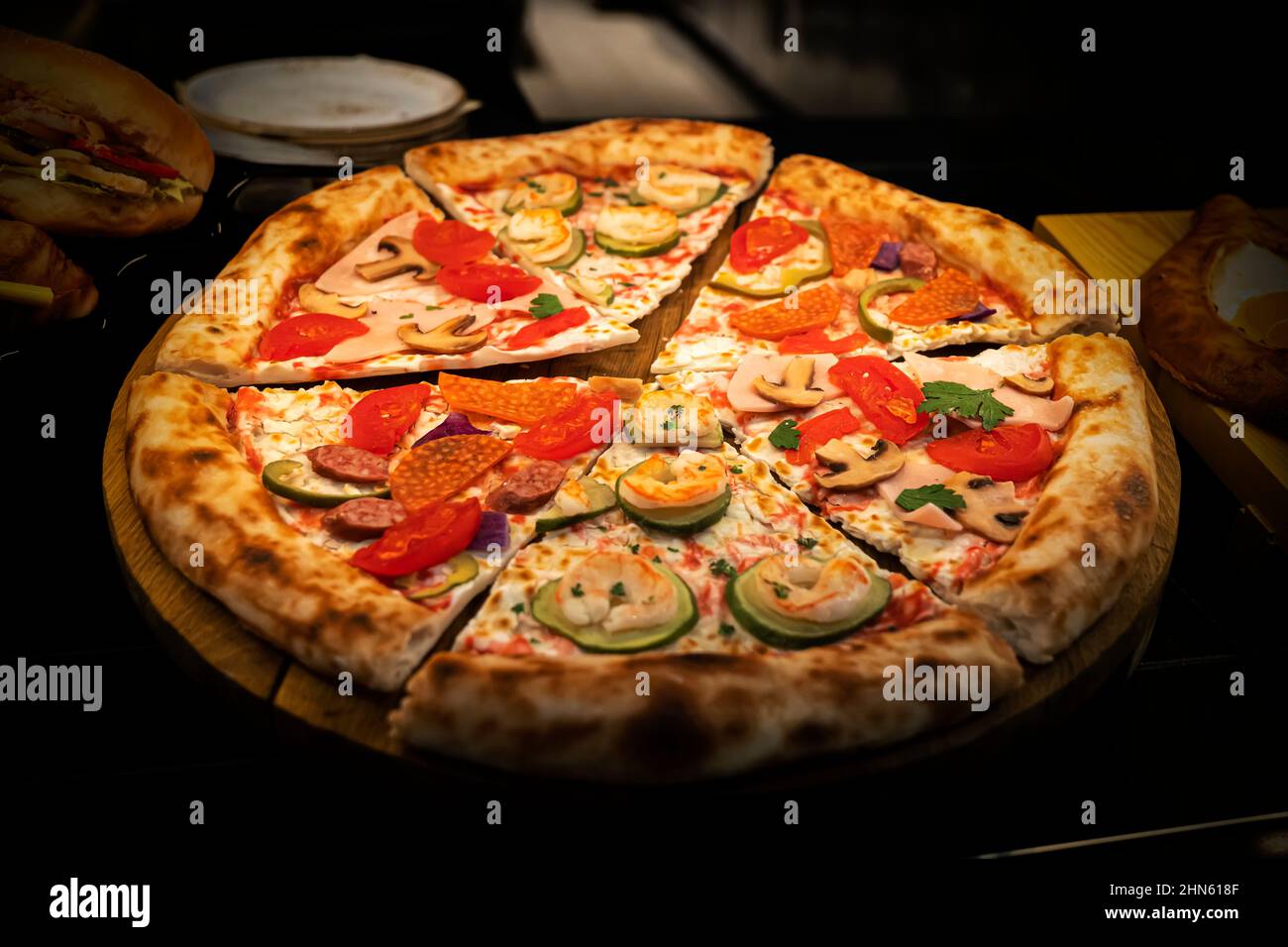 whole italian pizza on wood table with ingredients in the dark Stock ...