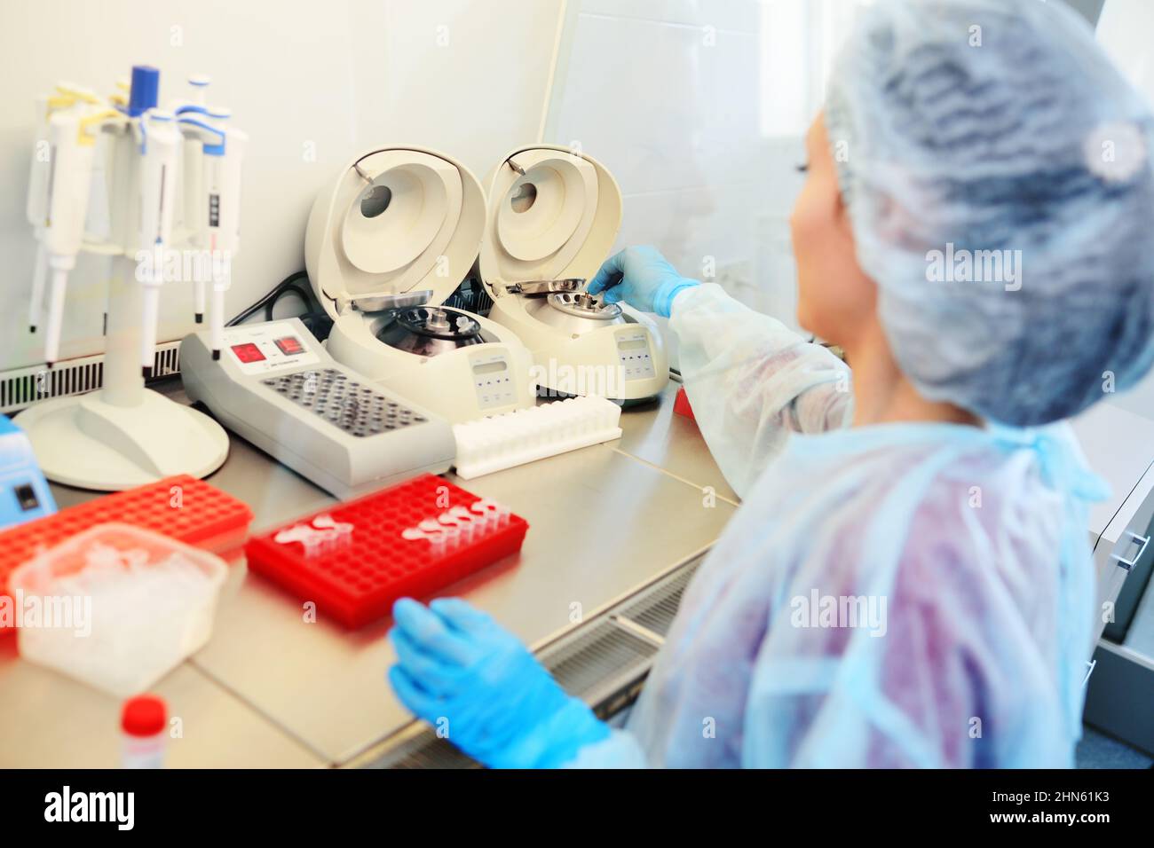 female scientist works in a sterile genetic or bacteriological ...