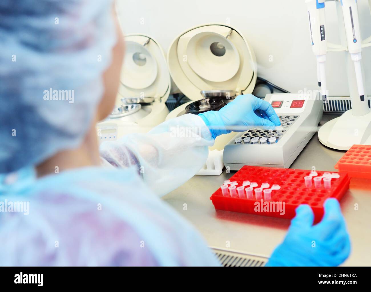 female scientist works in a sterile genetic or bacteriological ...