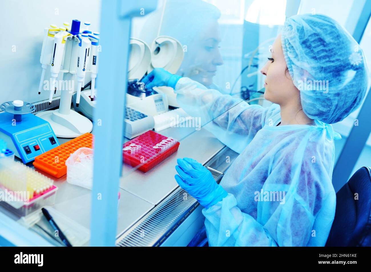 female scientist makes PCR DNA tests in a modern chemical and ...