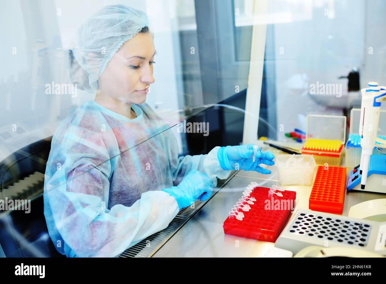 female scientist makes PCR DNA tests in a modern chemical and ...