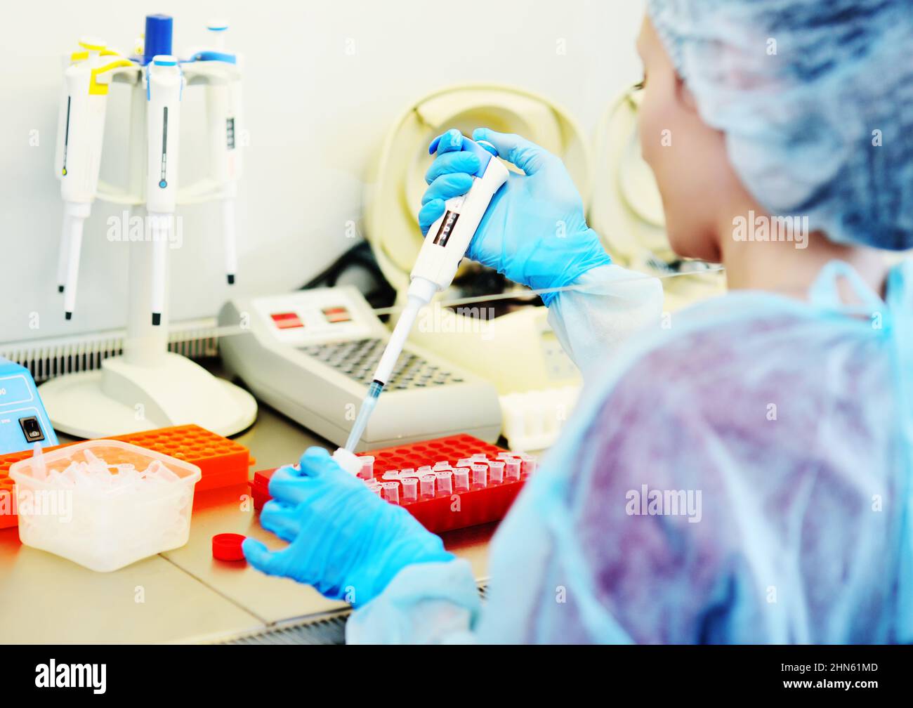 female scientist makes PCR DNA tests in a modern chemical and ...