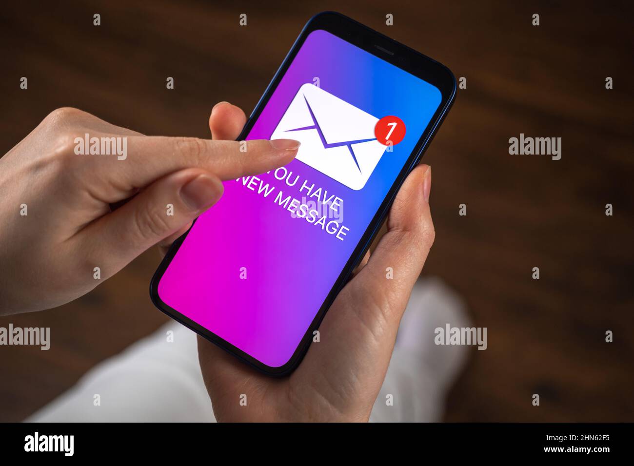 Smartphone and new message icon close-up. Woman using mobile phone with ...