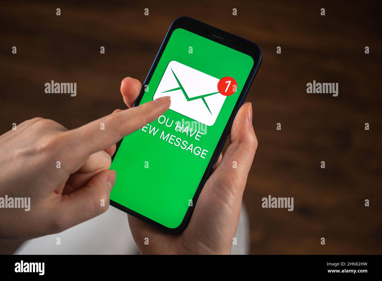 Smartphone and new message icon close-up. Woman using mobile phone with ...