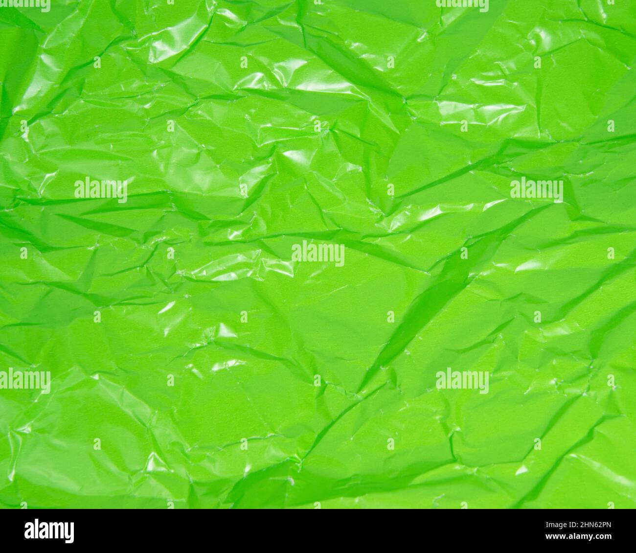 Crumpled green paper bright texture background Stock Photo - Alamy