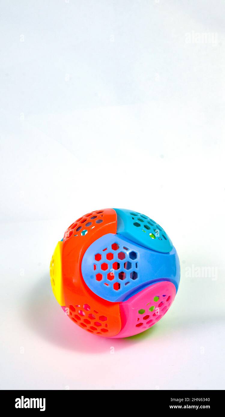 colorful hollow toy ball on an isolated white background,color concept ...