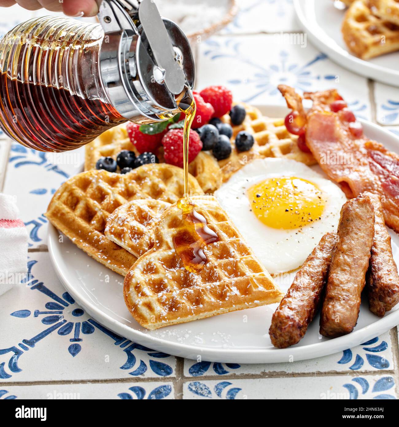 Breakfast table with waffles. fried egg, bacon and sausage Stock Photo ...