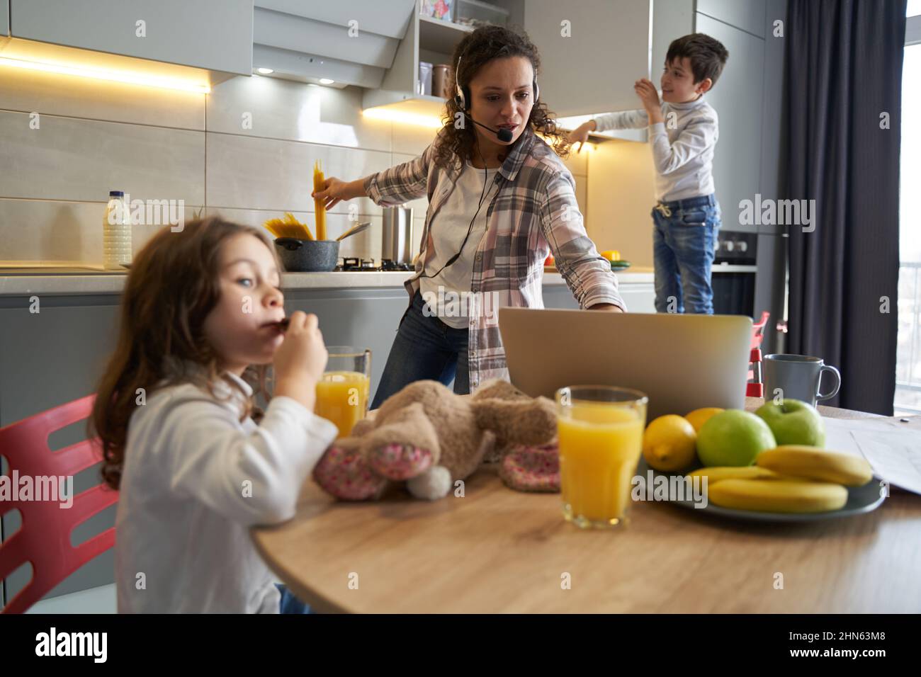 Woman typing on laptop keyboard while cooking Stock Photo - Alamy