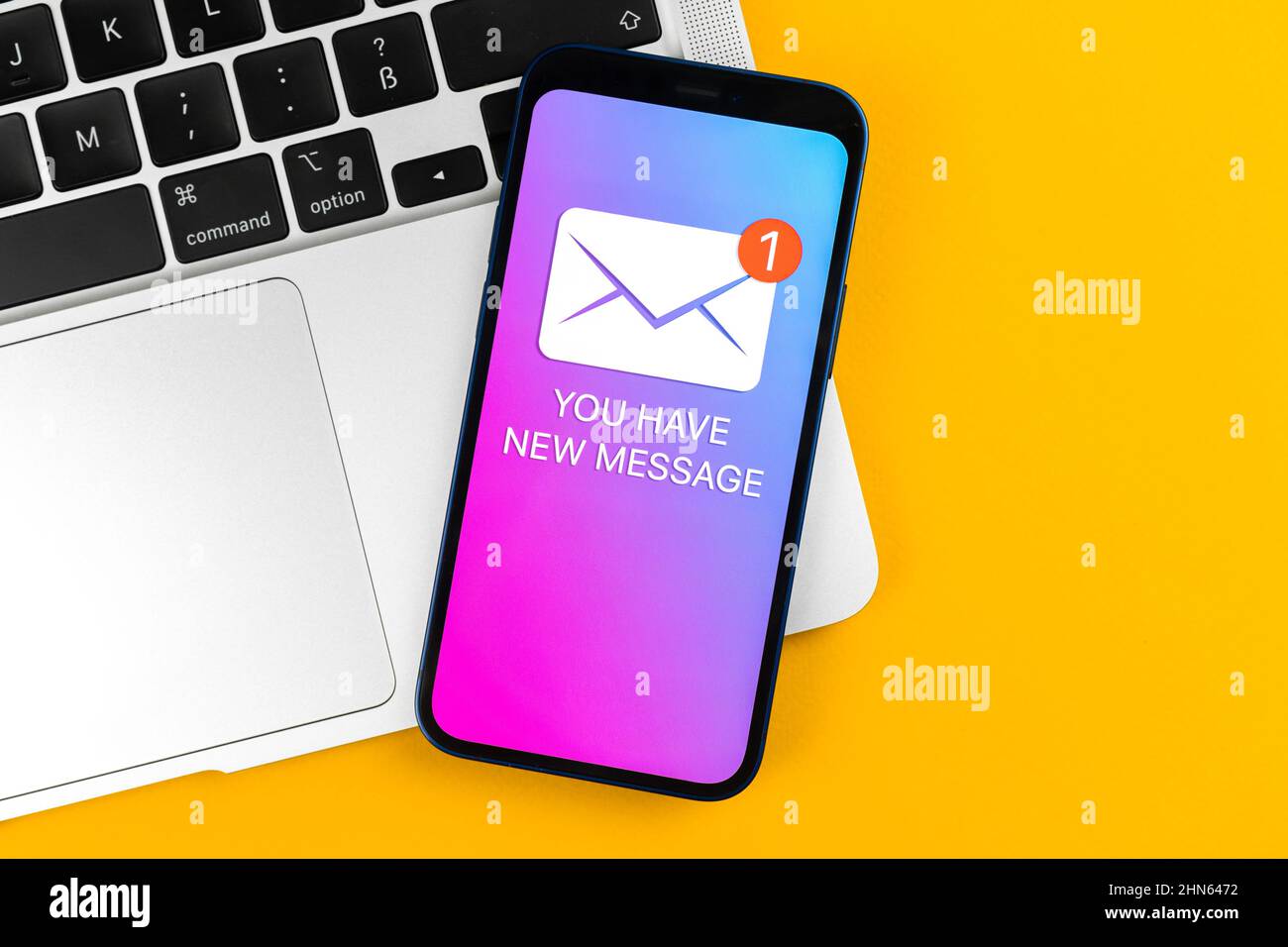 Smartphone and new message icon. Business workplace background with ...