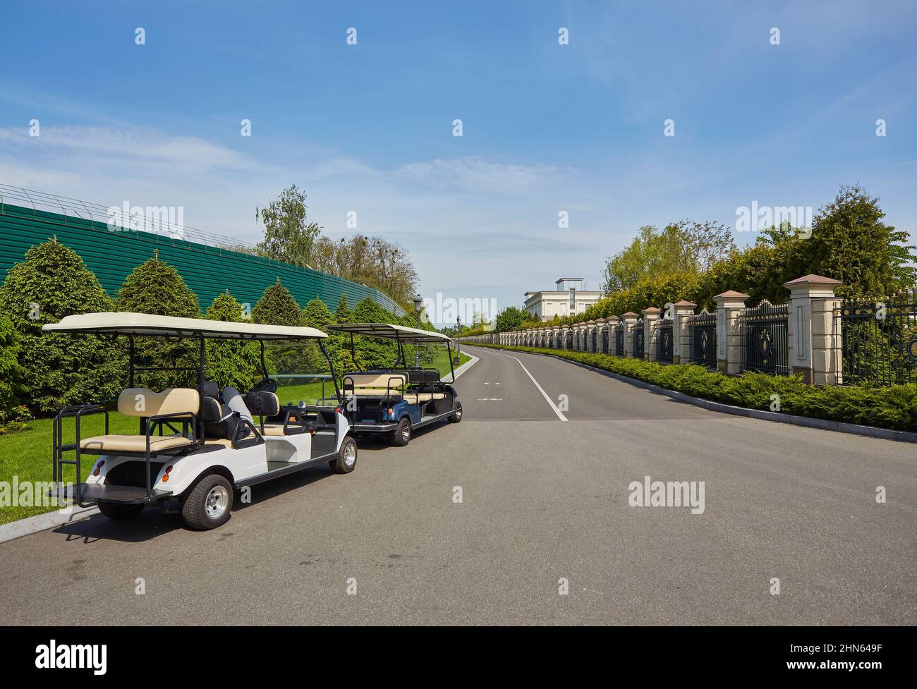 White golf cars park in the garden for service traveller Stock Photo ...
